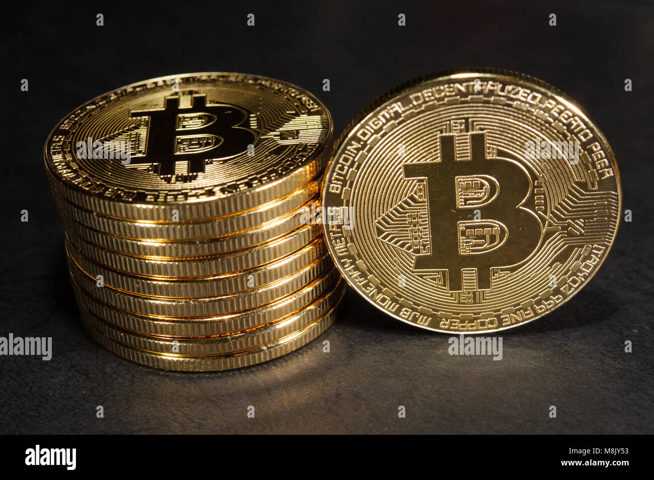 Column of bitcoins with one single coin next to them Stock Photo - Alamy