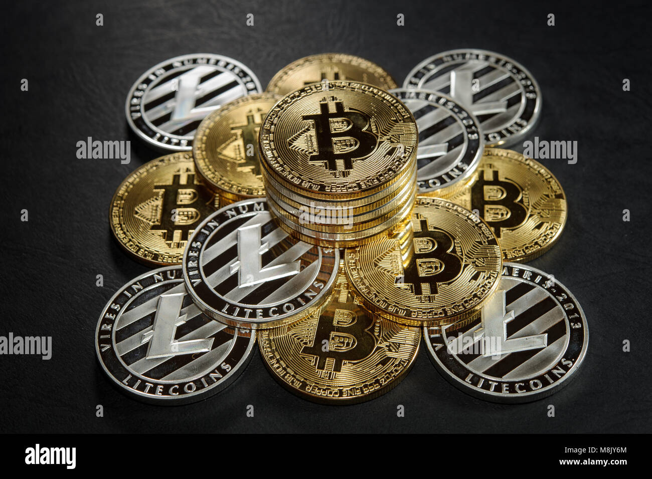 Pyramid from bitcoins and litecoins with stack of coins on the top ...