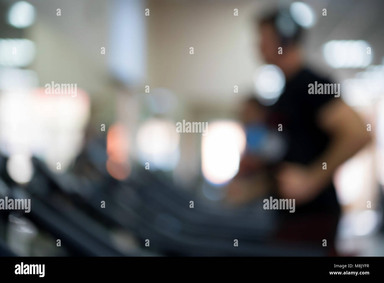 Blurred people in gym on treadmills Stock Photo - Alamy