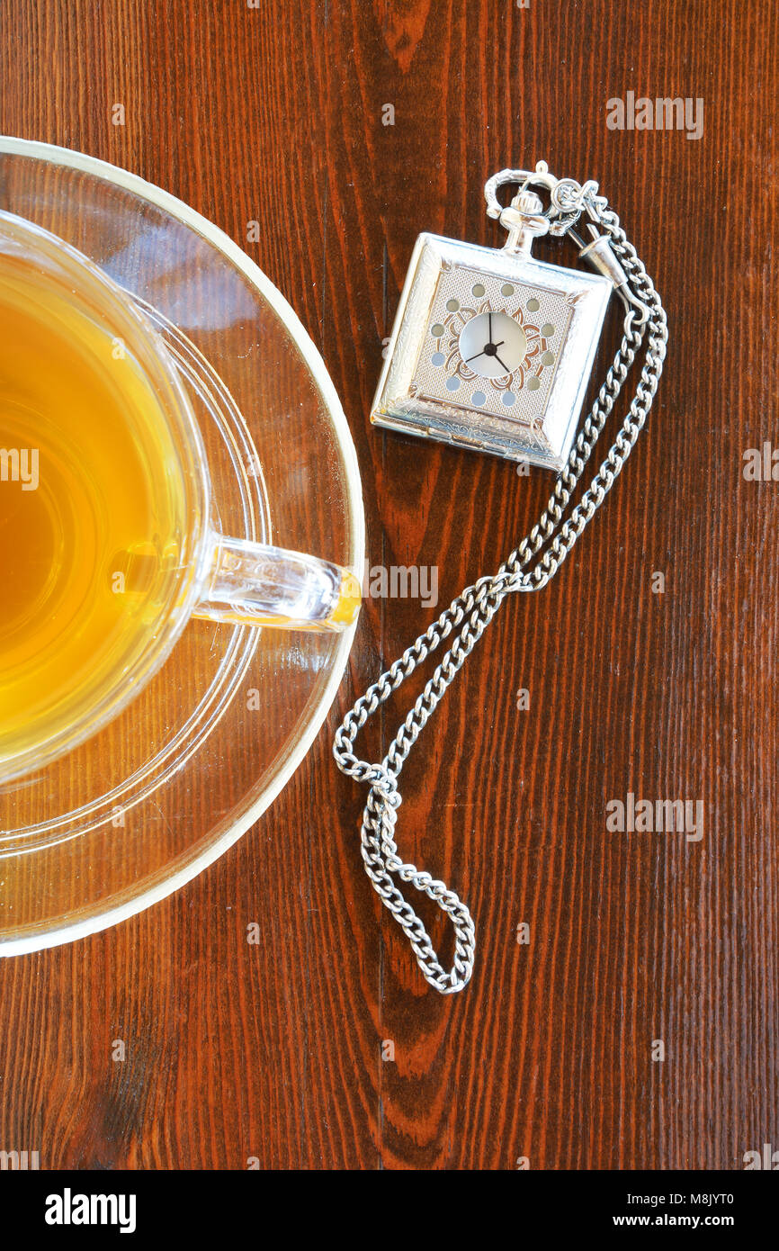 Cup of tea and antique pocket watch Stock Photo - Alamy