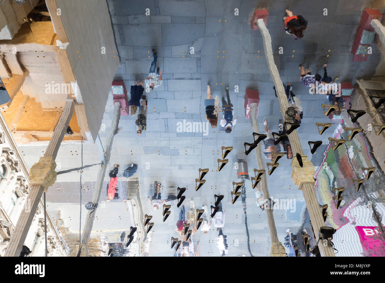 Unique entrance to retail store with shoe display on mirrored ceiling ...
