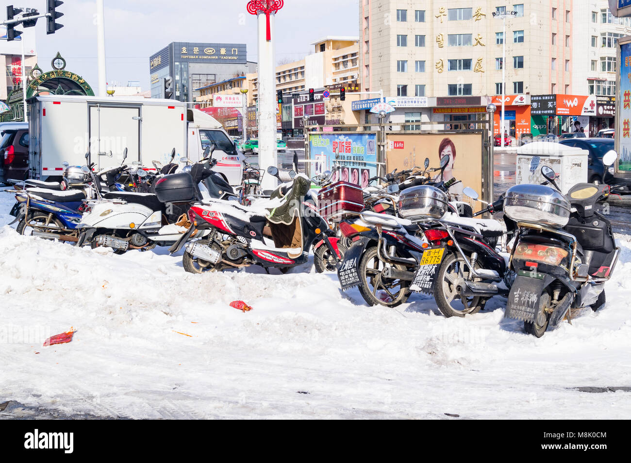 Hunchun, Jilin, China - 8 March 2018: Mopeds and motor scooters and ...