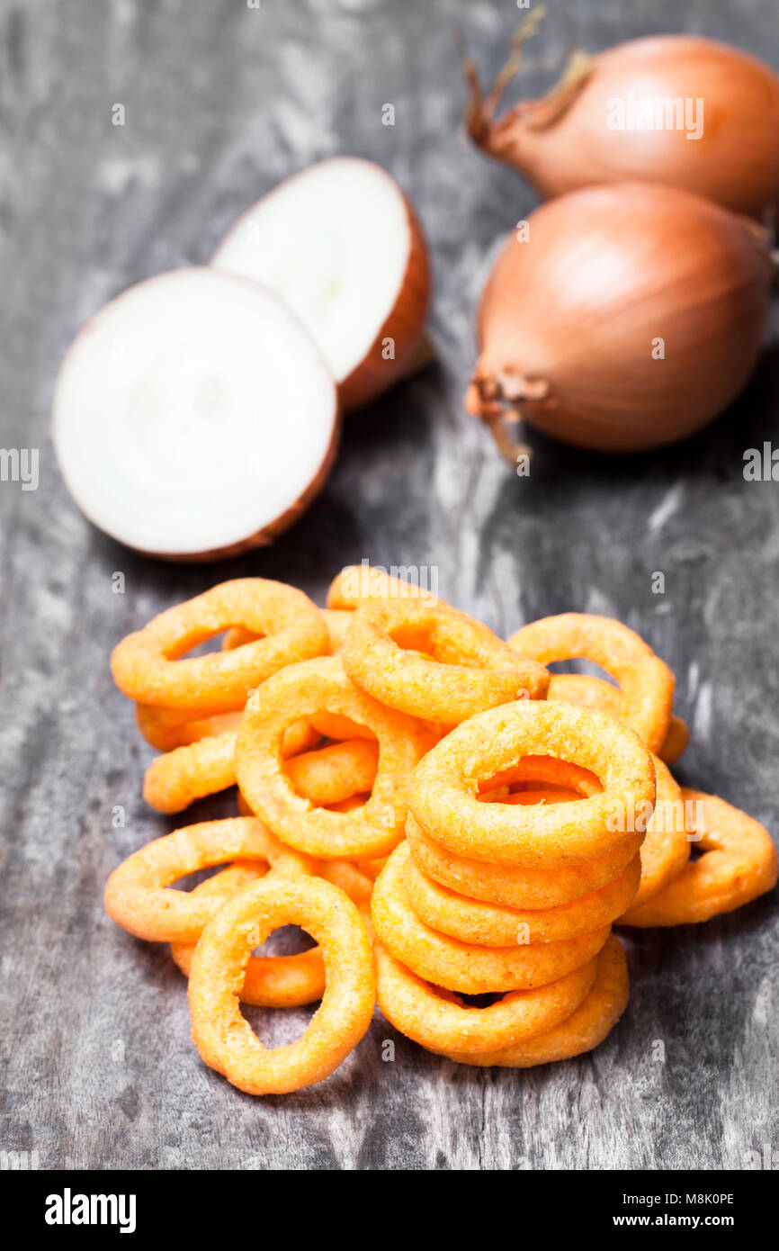 Crispy fried onion rings on wooden table Stock Photo - Alamy