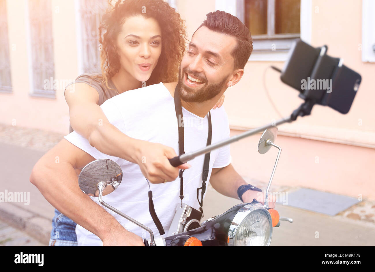 Happy couple on scooter making selfie on smartphone outdoor Stock Photo ...