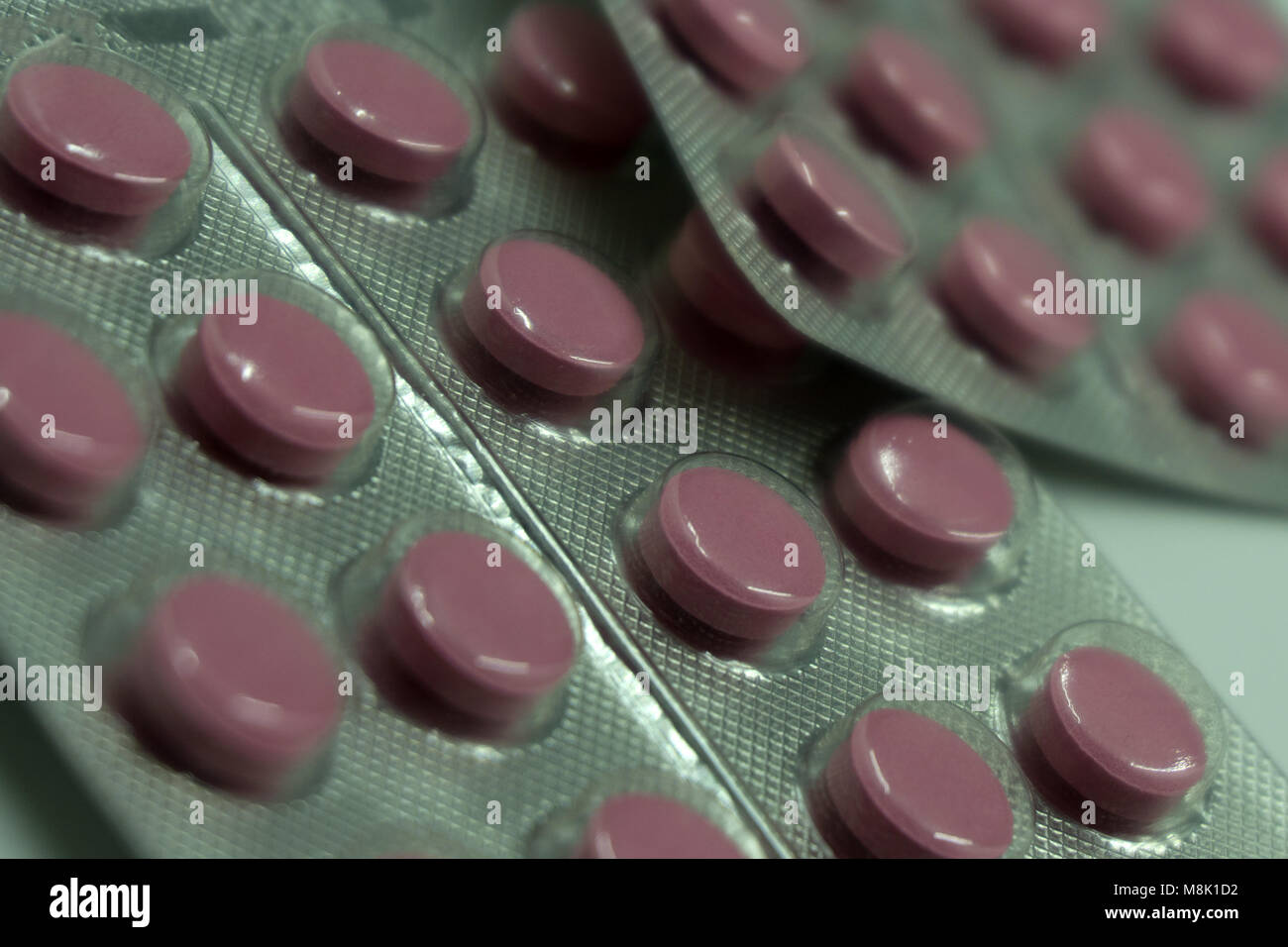 Pink tablet pills on white background Stock Photo - Alamy