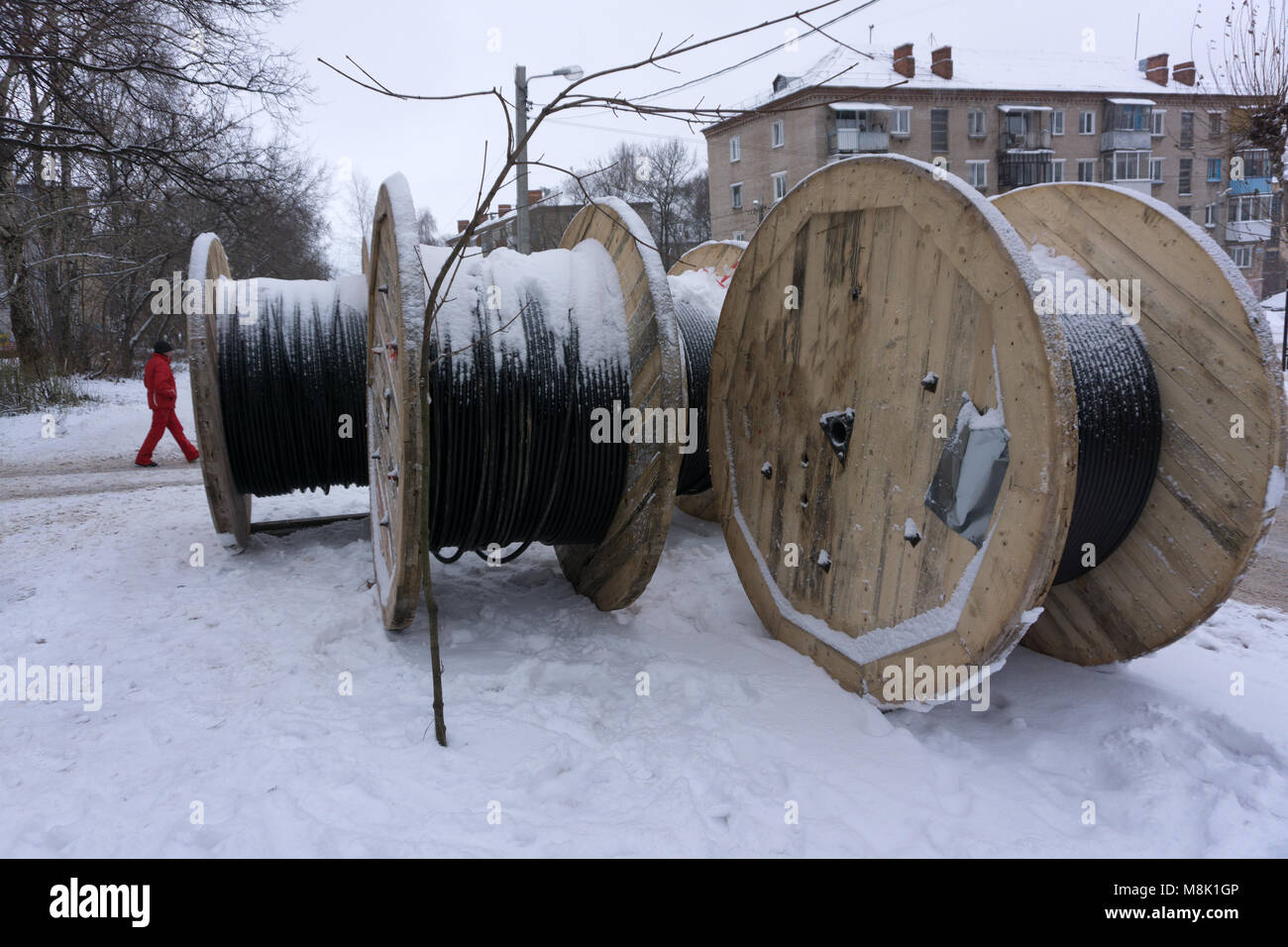 year roll of black industrial underground cable on big wooden coil at ...