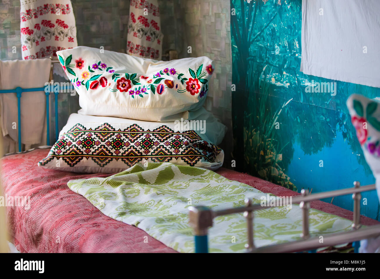 An ancient iron bed with embroidered cushions.Old Iron Bed with pillows ...