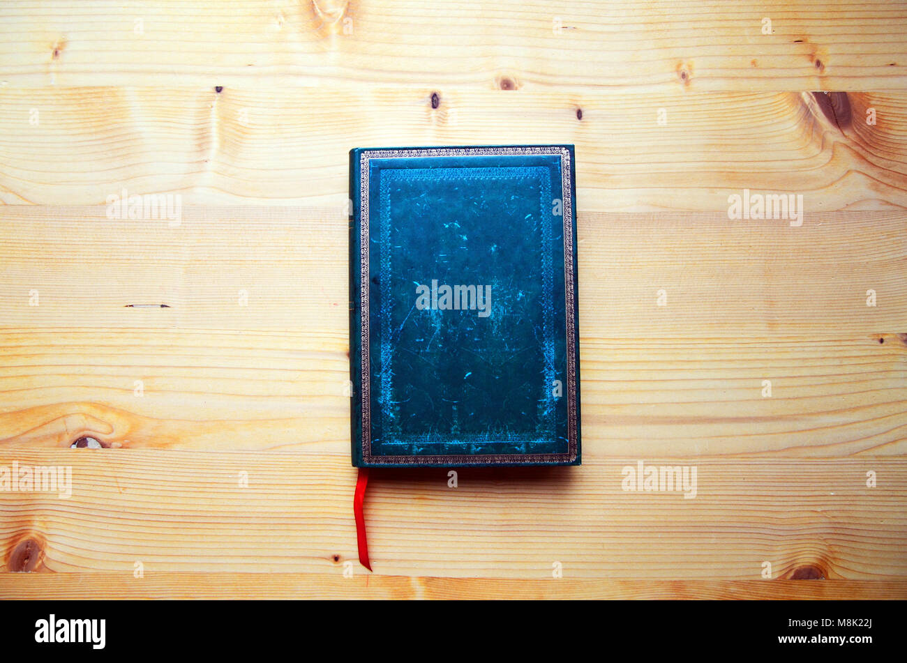 Dark green journal on wooden table Stock Photo - Alamy