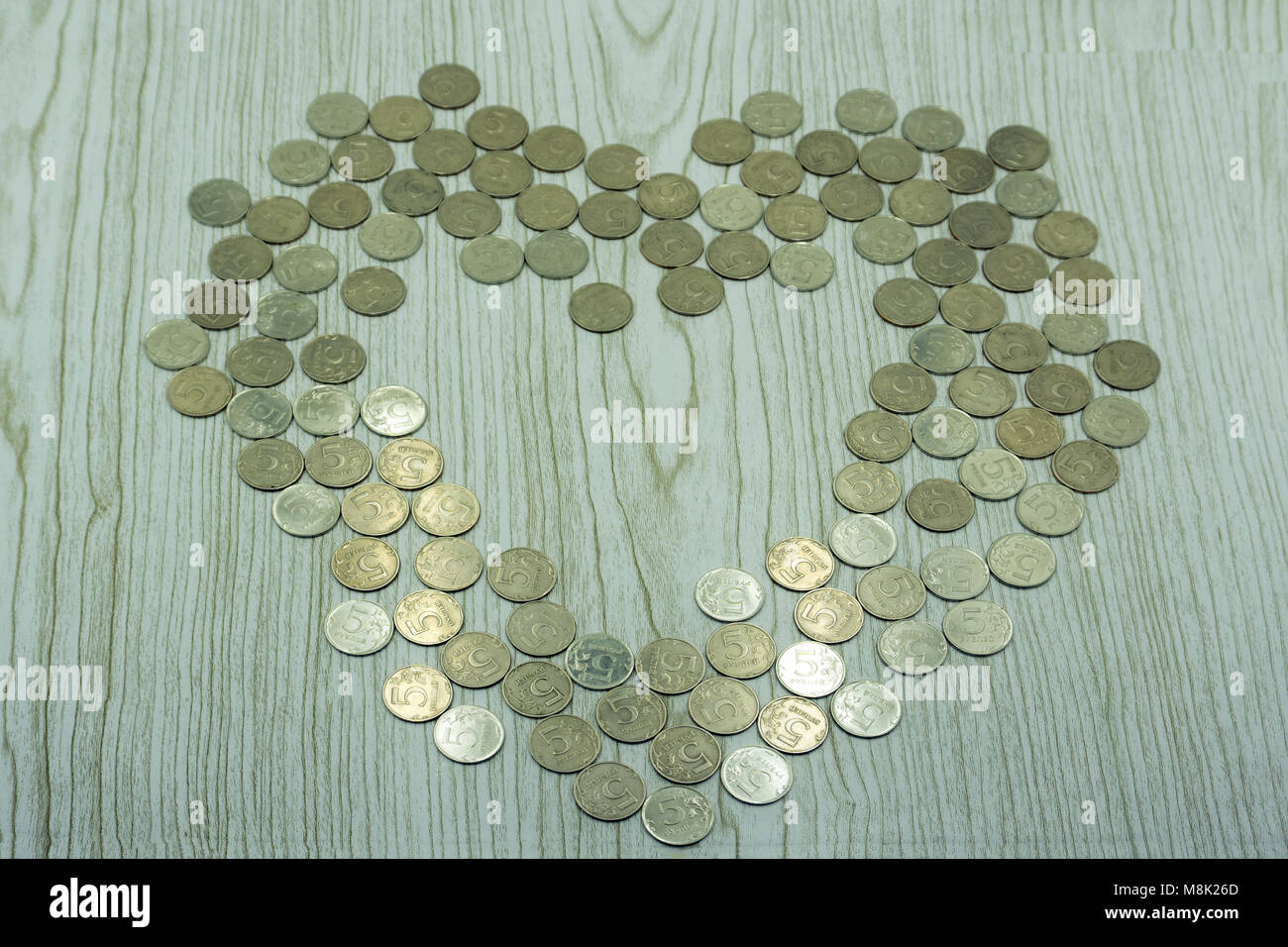 Twenty dollar bills making a heart symbol on a white background, money ...