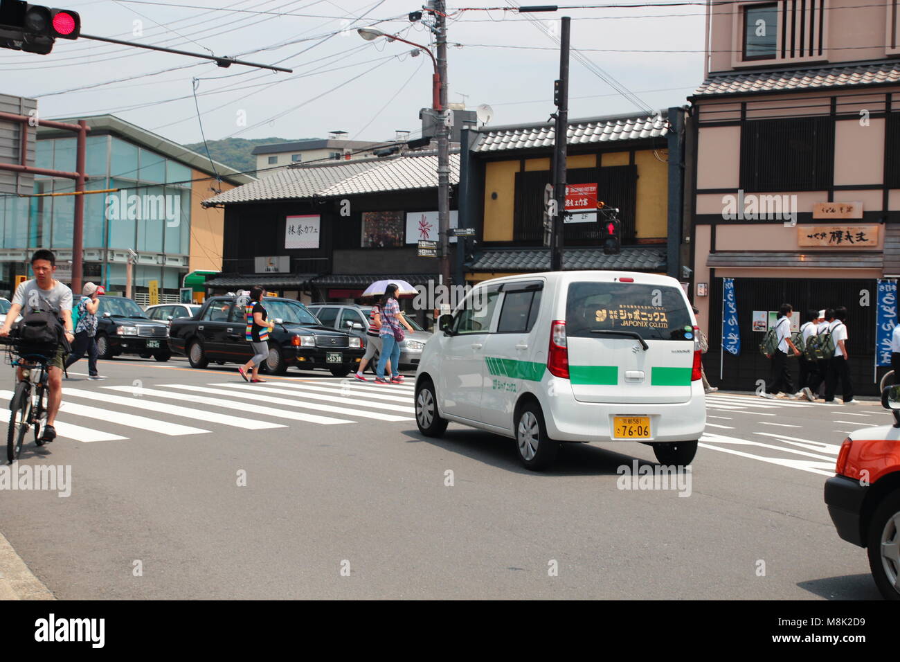 Pedestrians cross the street using the Zebra crossing at Gion area in ...