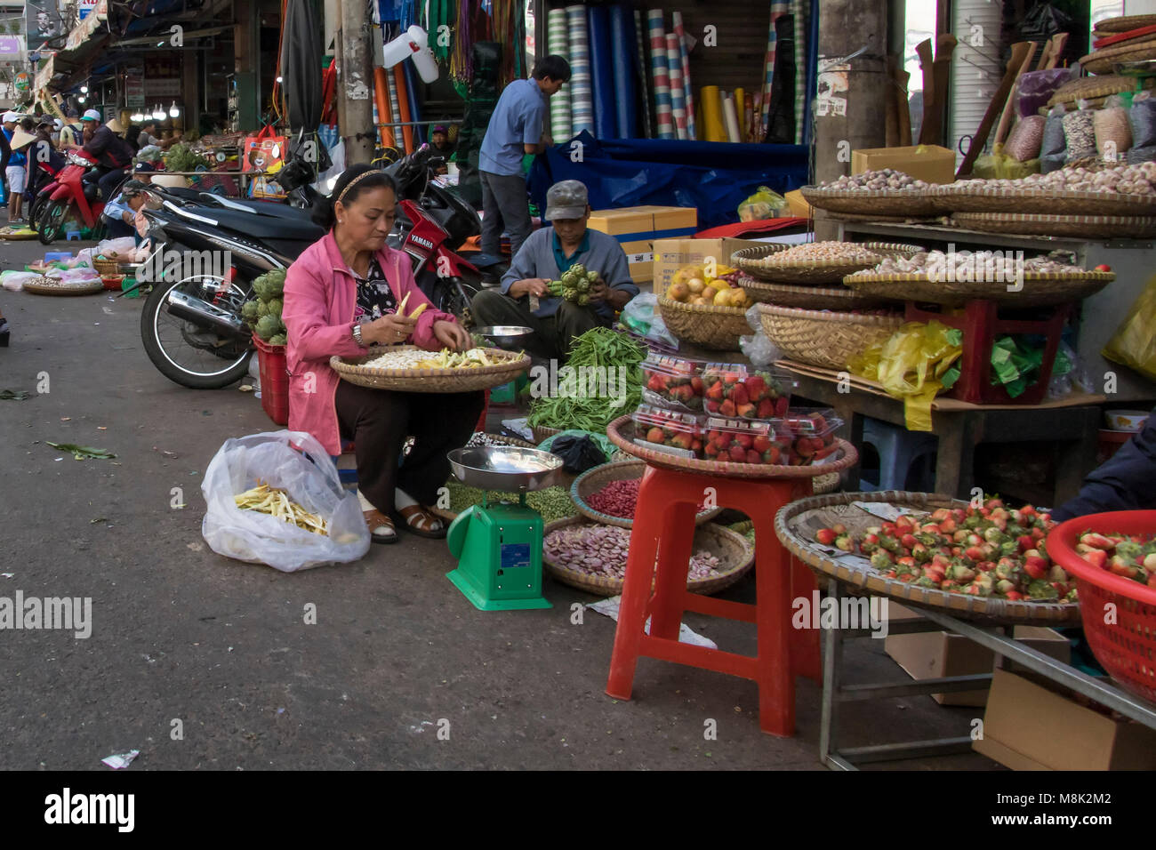 Woman tending to her Market Stall Stock Photo - Alamy