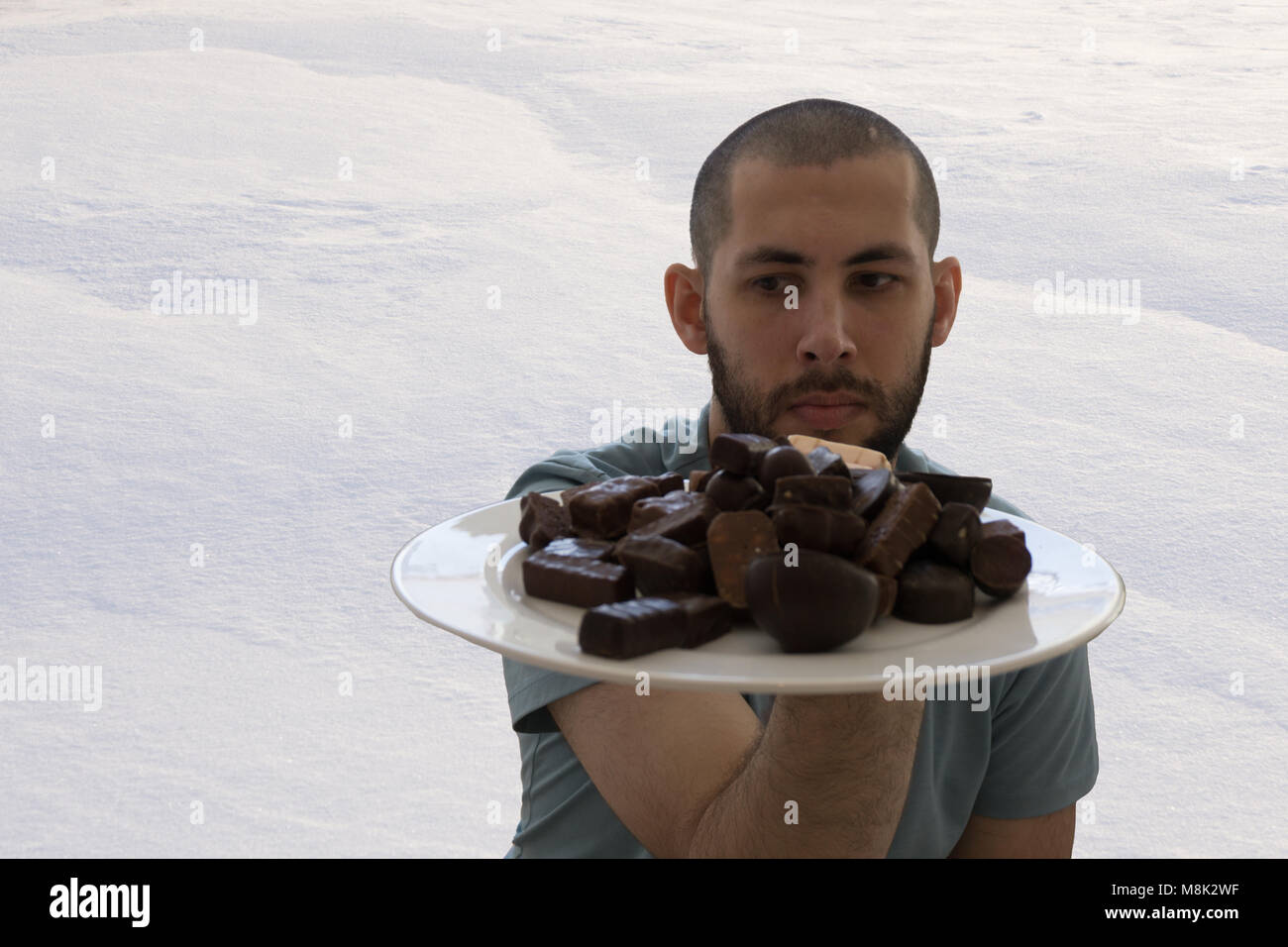 Man in suit holding dates plate in front Stock Photo - Alamy