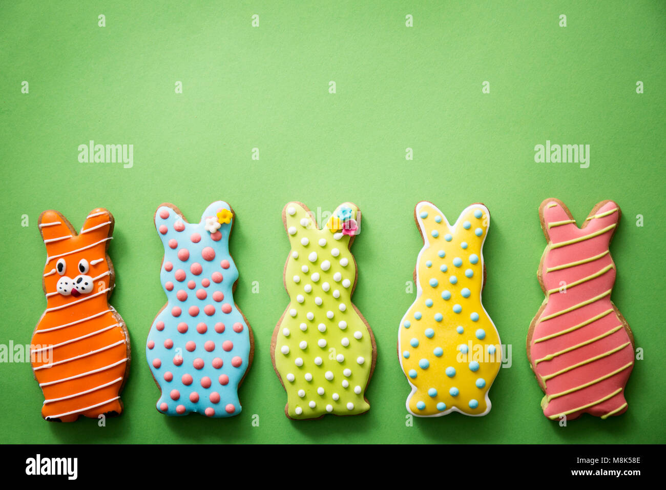 five rabbits on a green background Stock Photo - Alamy