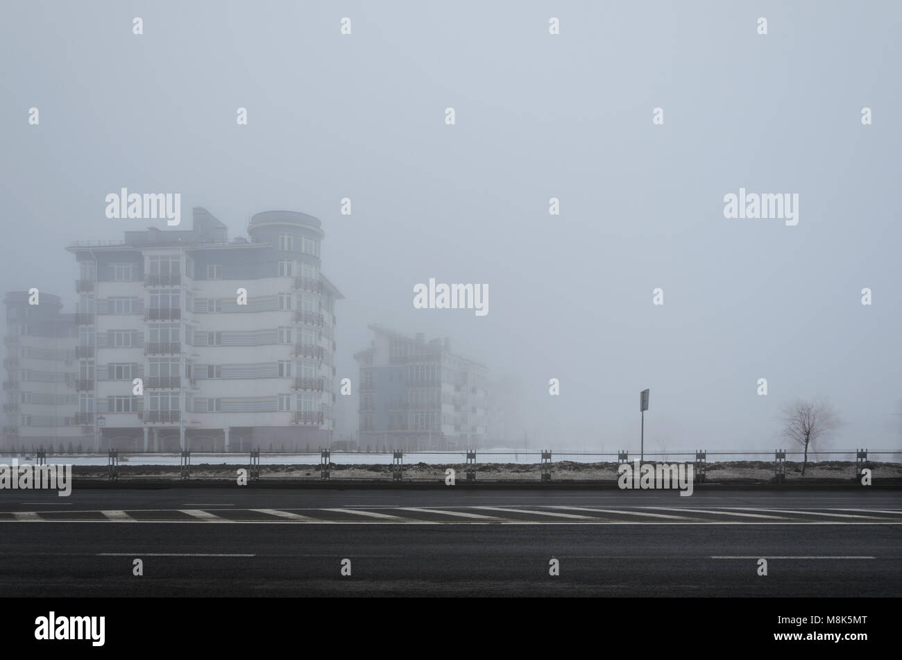 Mystical landscape of residential low-rise houses in dense fog Stock ...