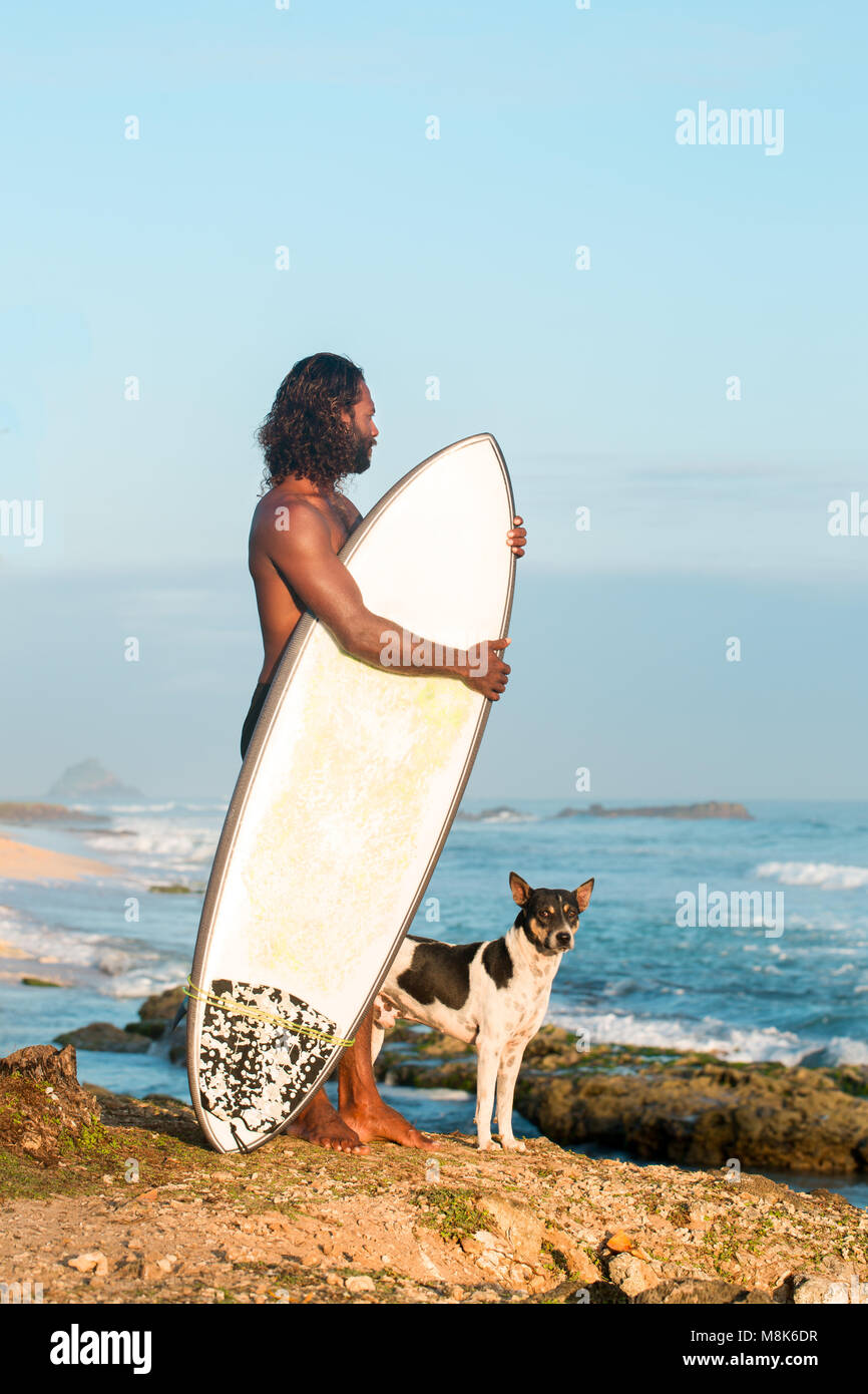 surfer with a dog by the ocean Stock Photo - Alamy