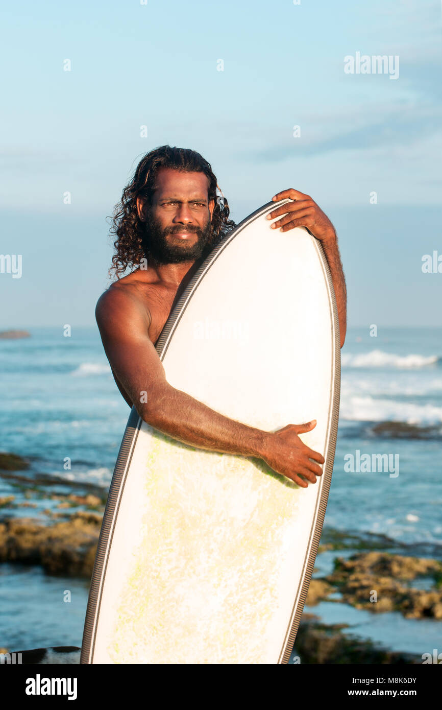 the surfer hugs the surfboard Stock Photo - Alamy