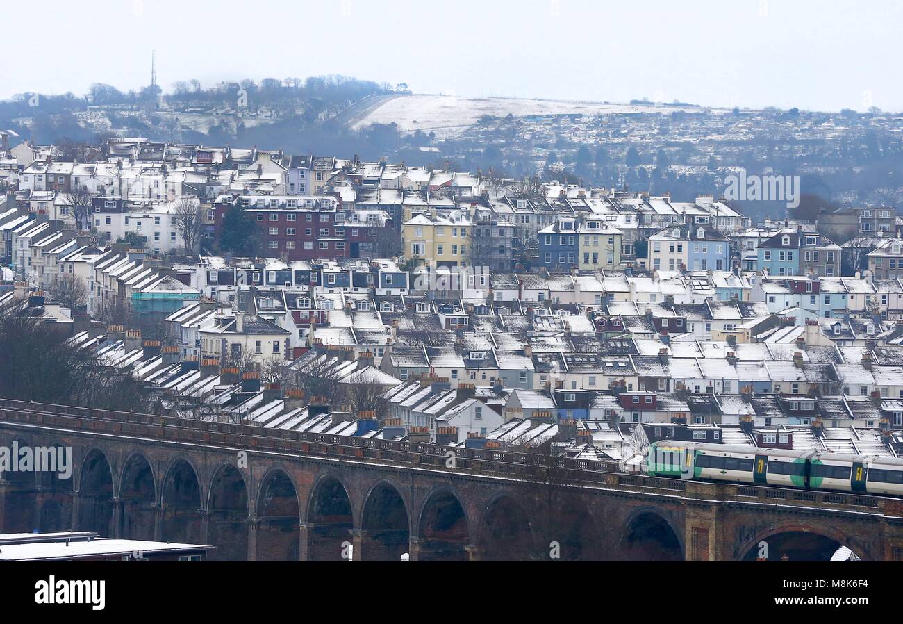 Snow covered houses are seen as a train crosses London Road Viaduct in ...