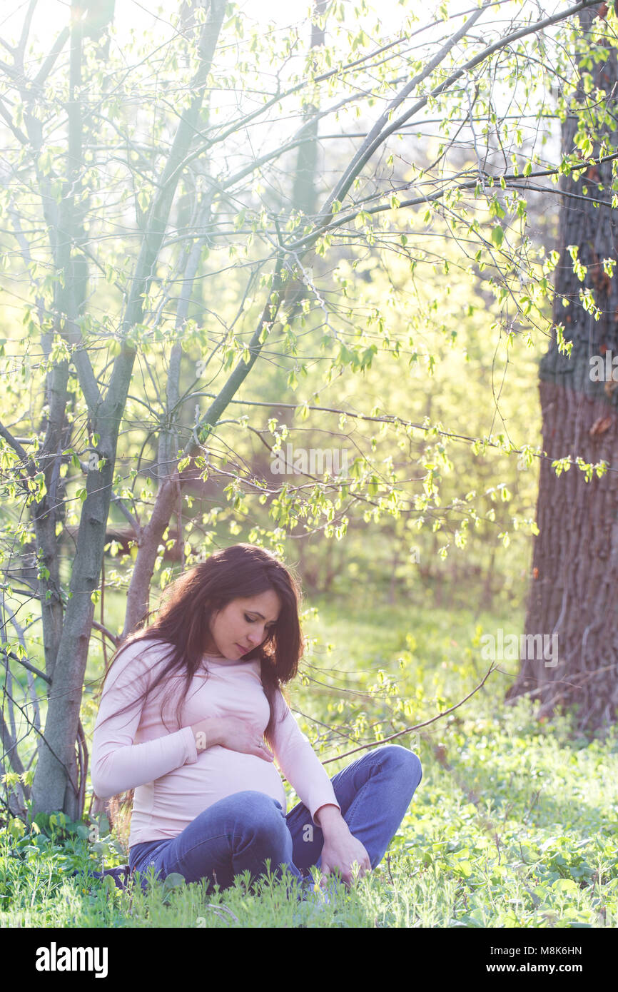 A woman is sitting under a tree Stock Photo - Alamy