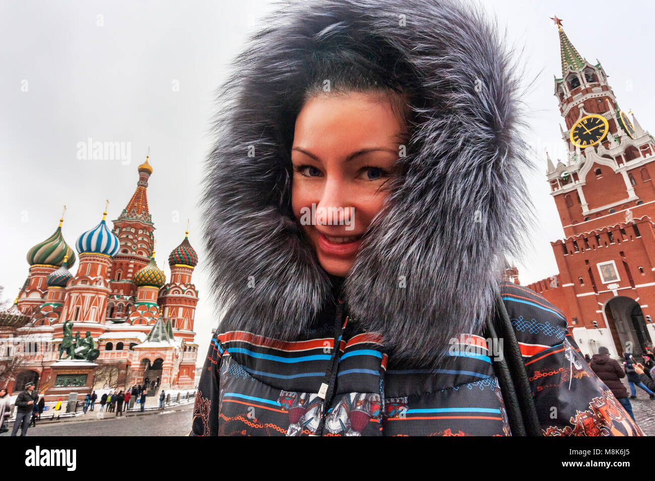 Portrait of a happy woman posing between St. Basil s Cathedral and ...