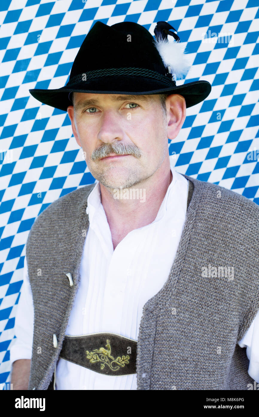 portrait of handsome bavarian man on blue and white background Stock ...