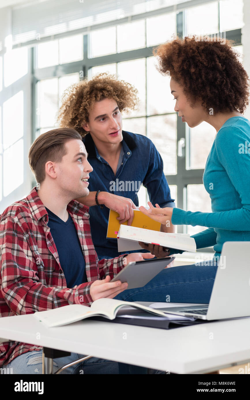 Three involved students sharing ideas and opinions about differe Stock ...