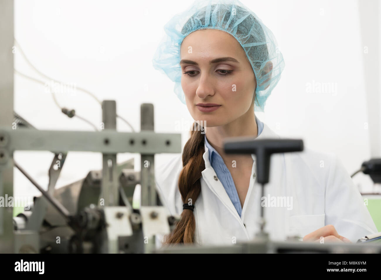 Portrait of woman quality inspector during work in cosmetics factory ...