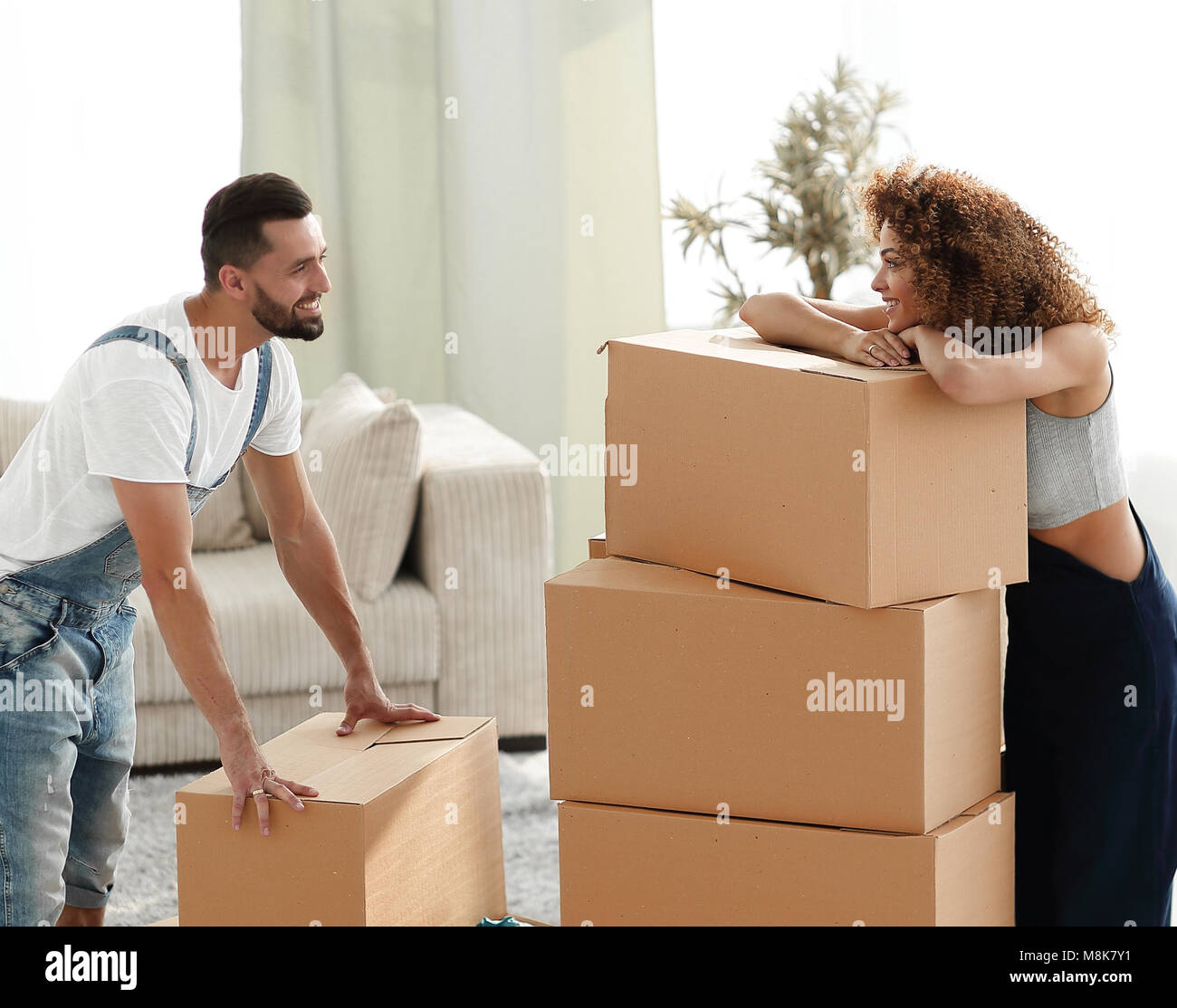 Happy and young couple looking at boxes Stock Photo - Alamy