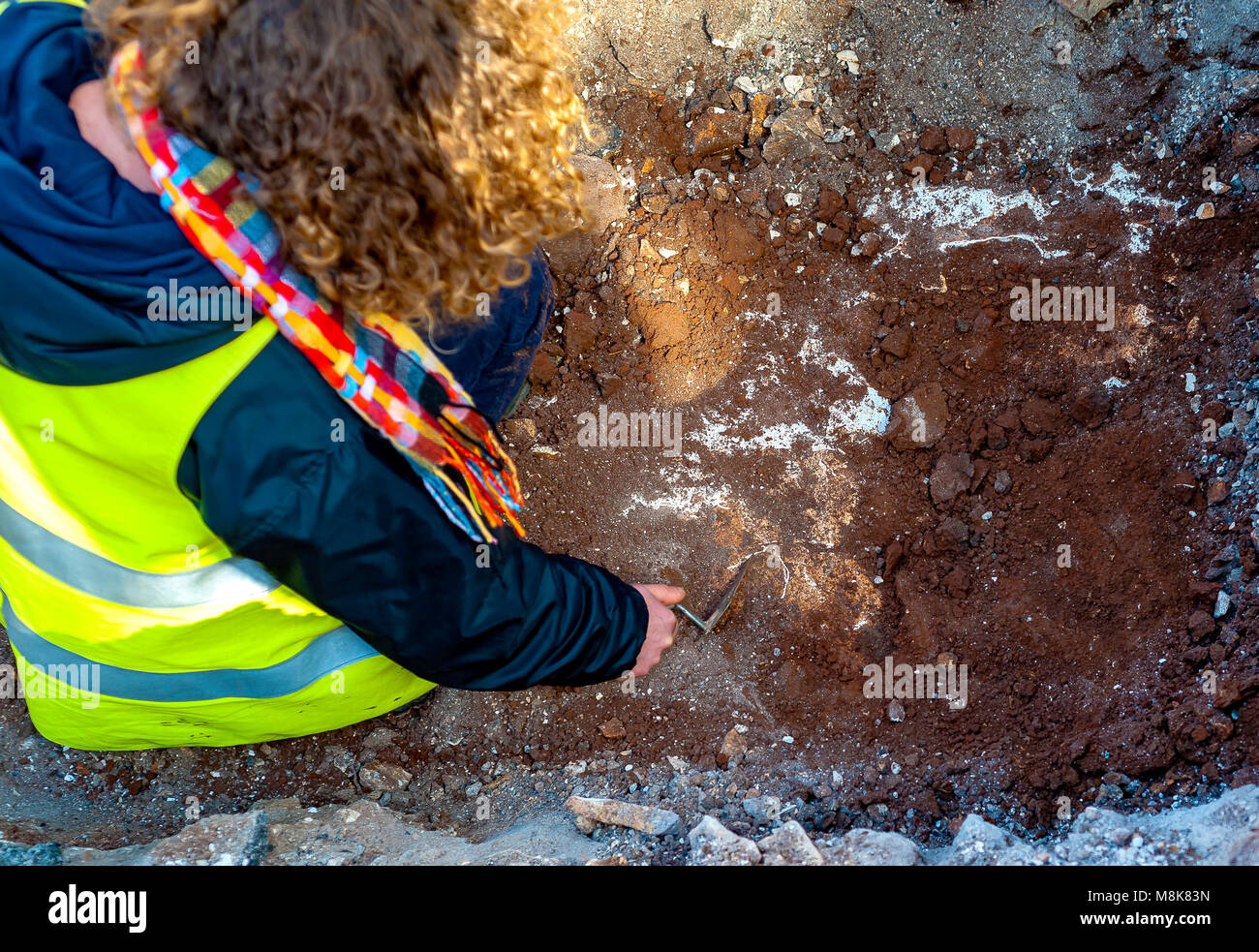 Archeology excavation site with man digging in the ground Stock Photo ...