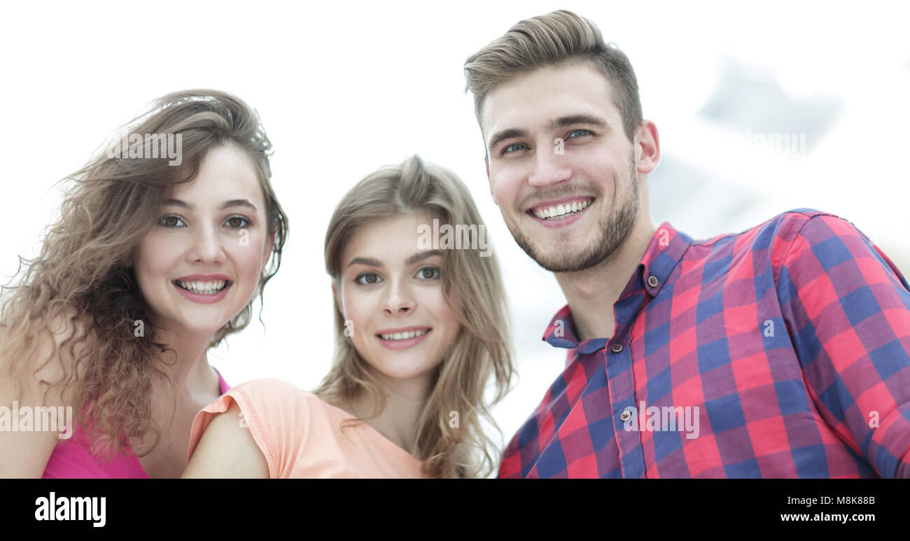 closeup of three young people smiling on white background Stock Photo ...