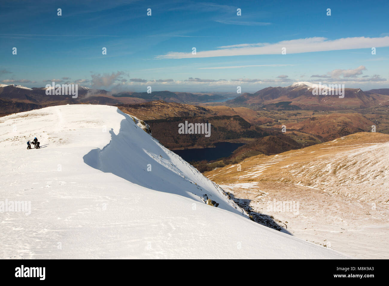 Mountaineers approaching the summit of Helvellyn in full winter ...