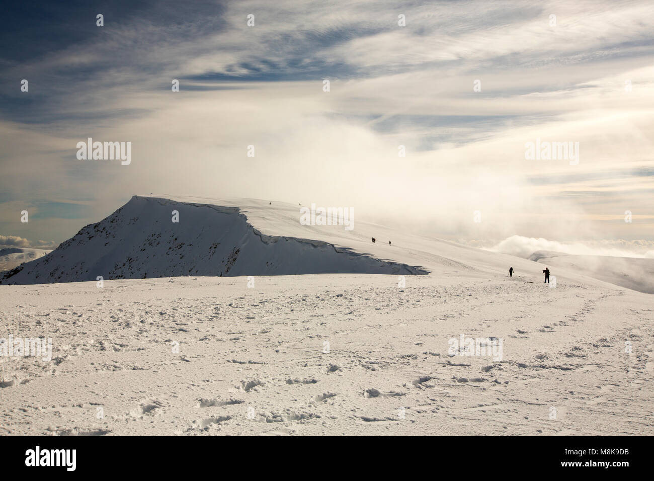 Mountaineers approaching the summit of Helvellyn in full winter ...