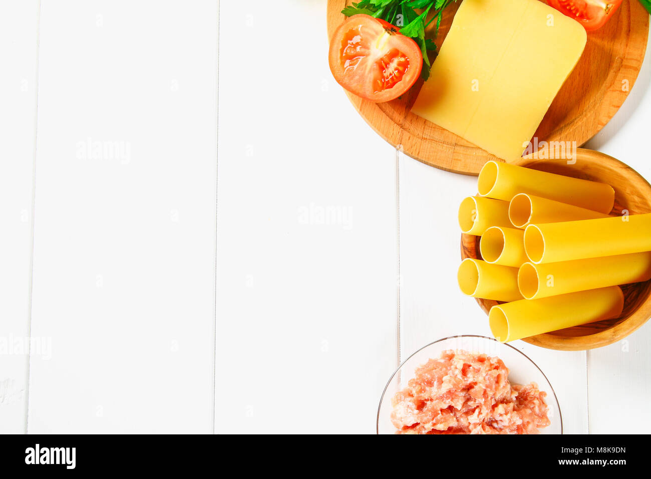 Italian pasta cannelloni. Raw tube for stuffing stuffing surrounded by ...