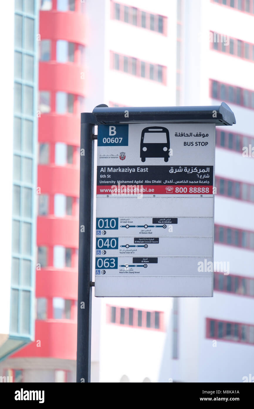 Close-up of a bus-stop sign / post isolated against buildings at Hamdan ...