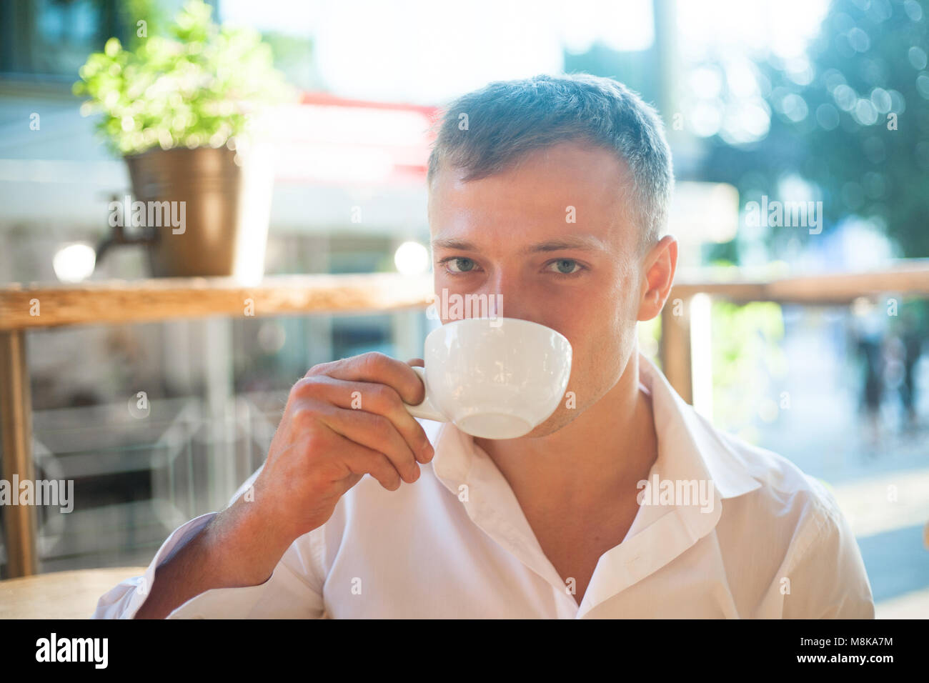 Young man enjoy on coffee break, outdoors portrait Stock Photo - Alamy
