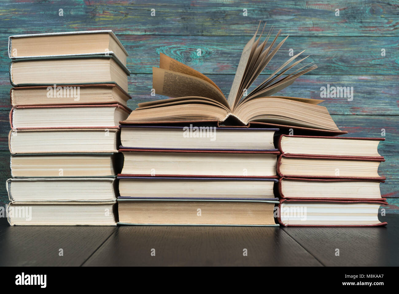 Open book hardback on Stack books Stock Photo - Alamy