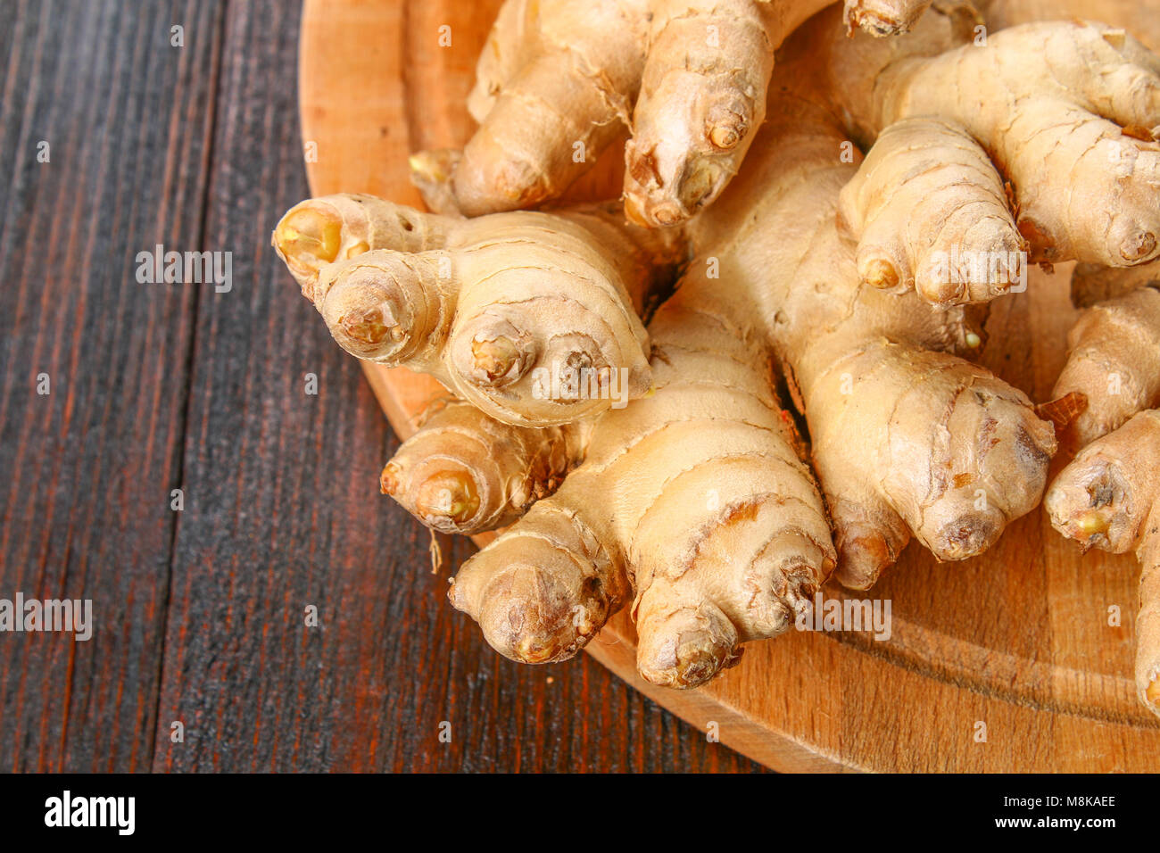 Spicy root of ginger on a wooden table Stock Photo - Alamy
