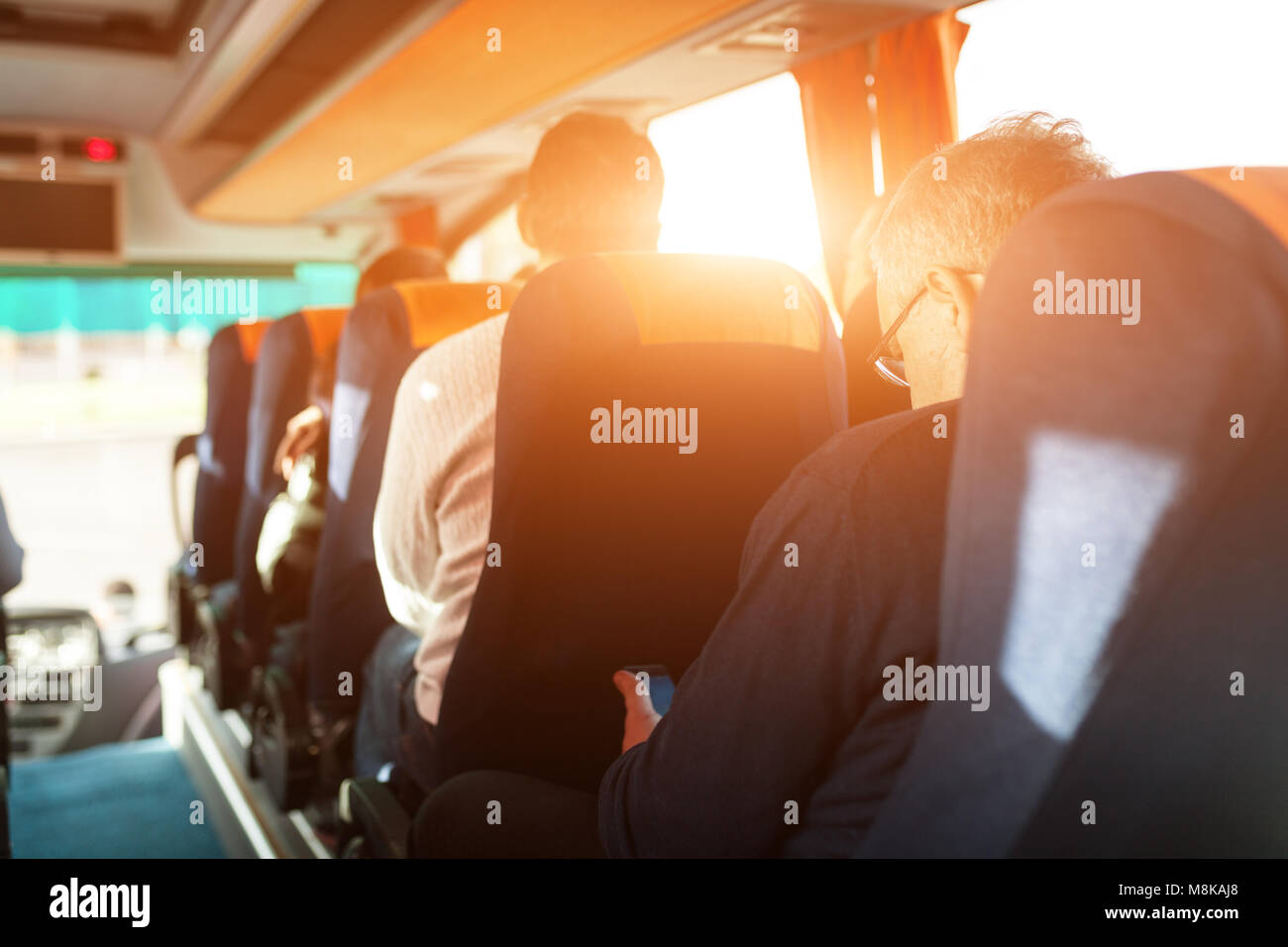interior of bus with passengers rear view with sunlight Stock Photo - Alamy
