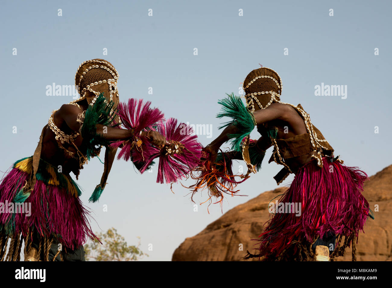 Two masked indigenous Dogon men in traditional costumes taking part in ...