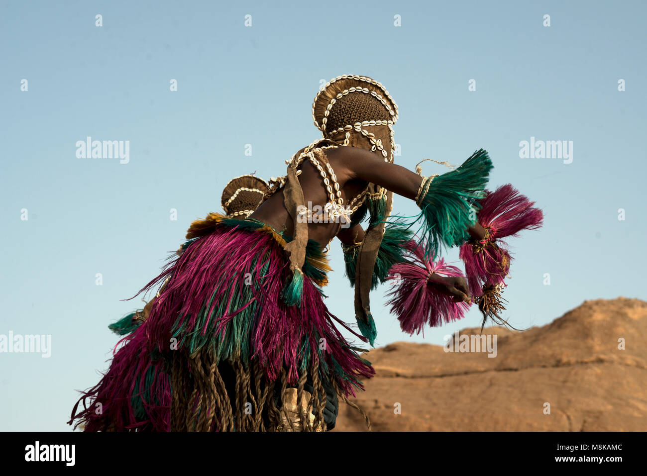 A Dogon man is a masked dancer as he participates in an ancient tribal ...