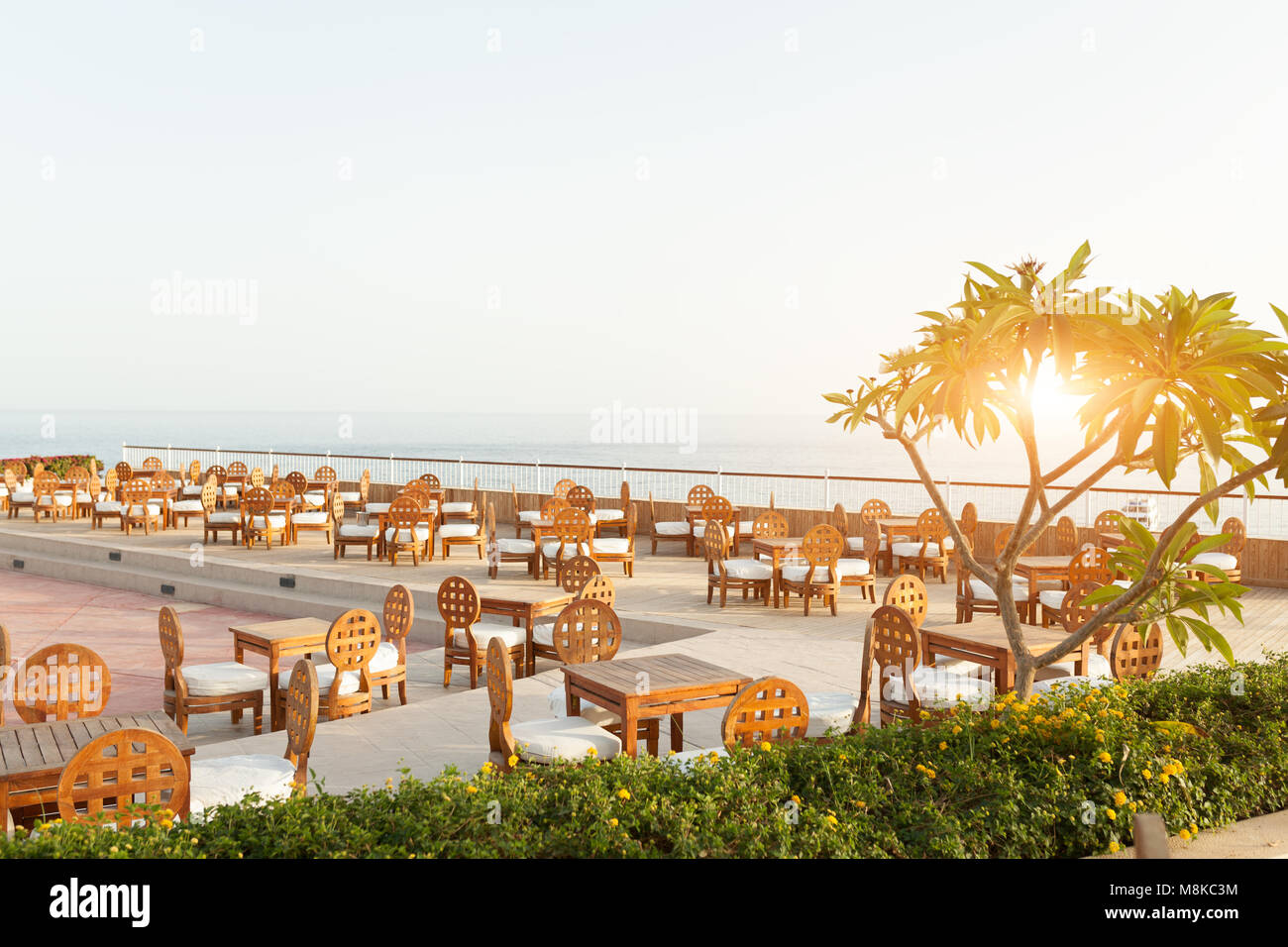 Outdoor luxury cafe restaurant in the tropical country with palm tree ...