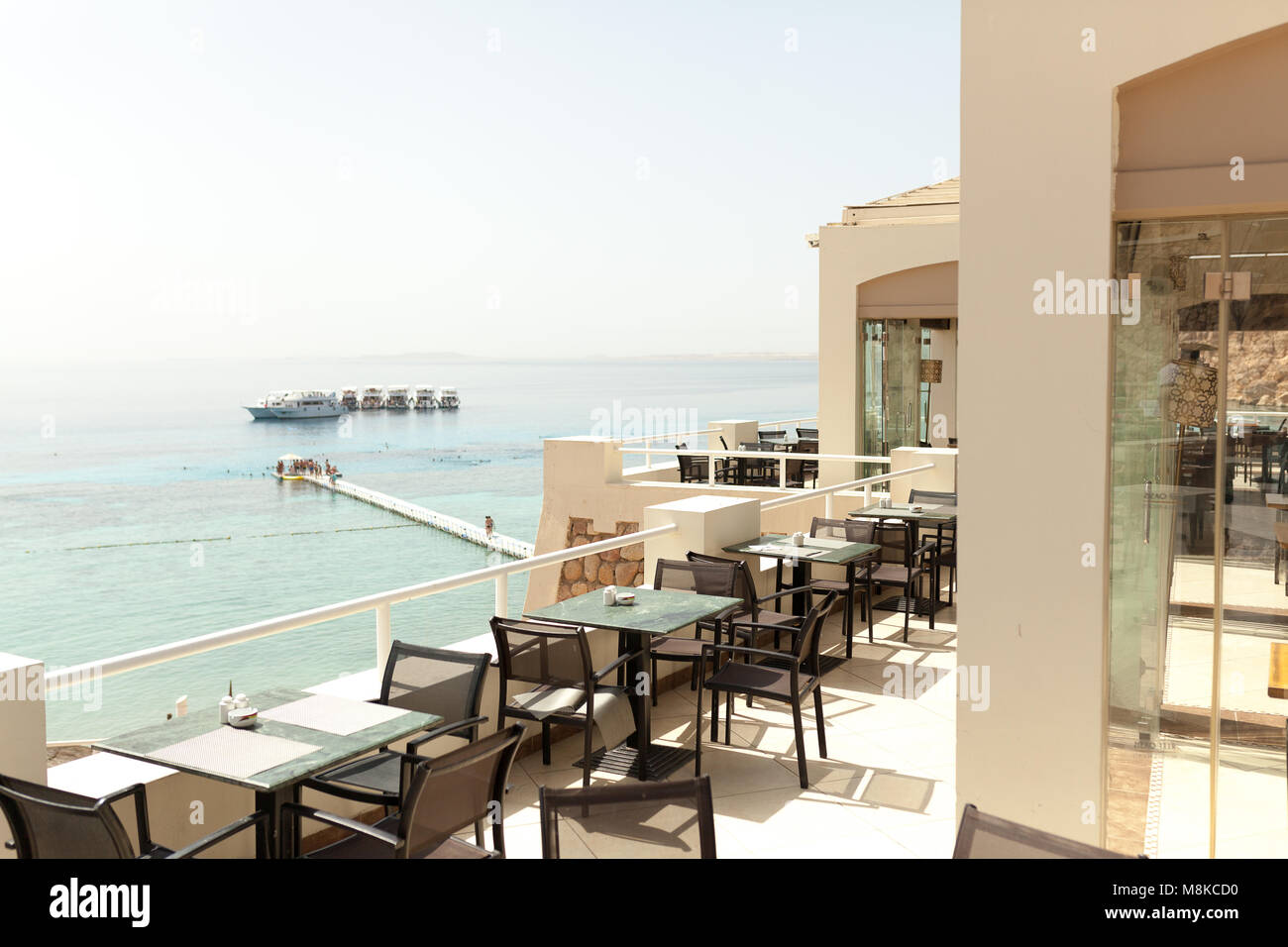 Outdoor luxury cafe restaurant in the tropical country with palm tree ...