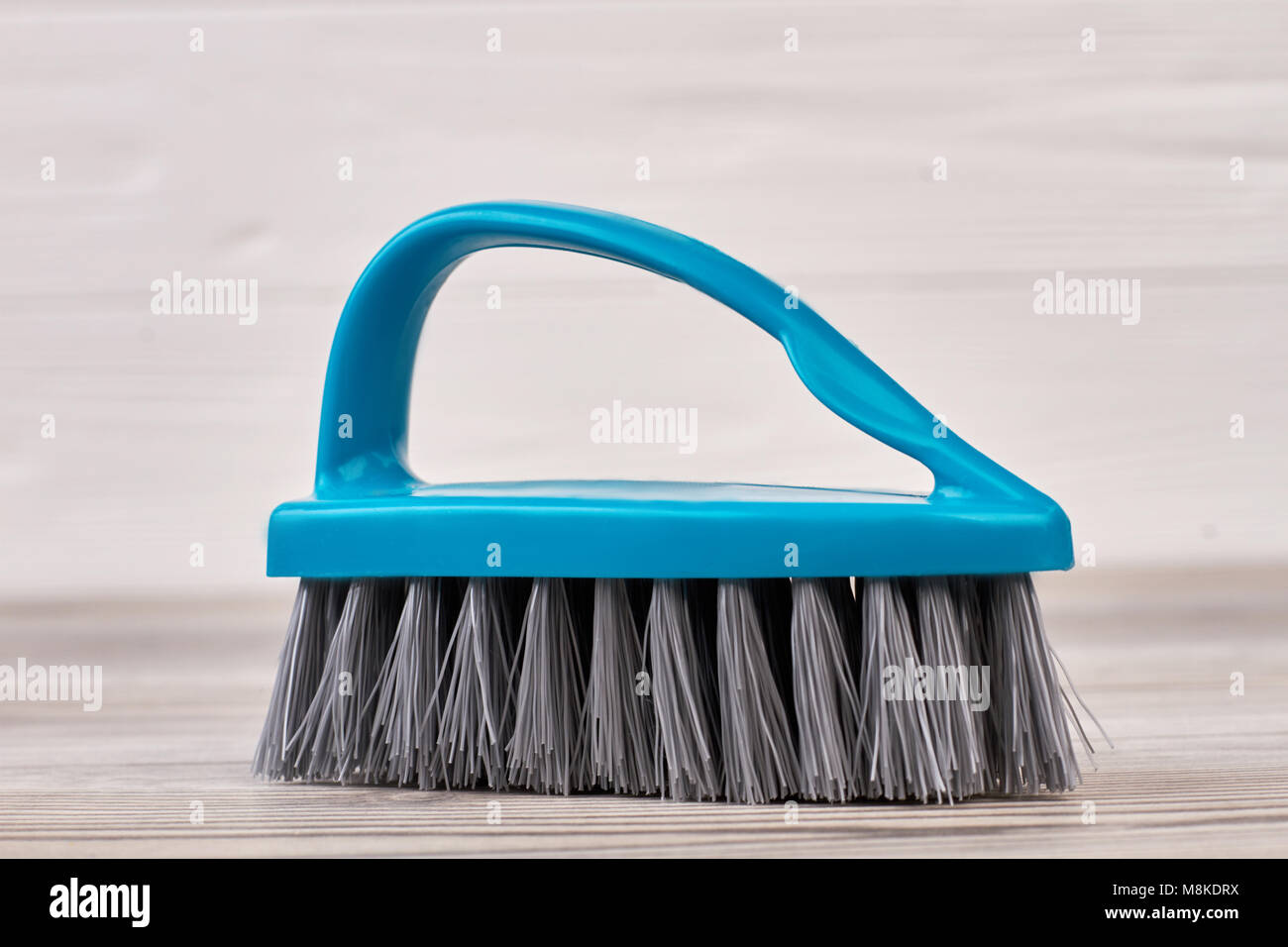 Blue clothes brush with a handle Stock Photo - Alamy