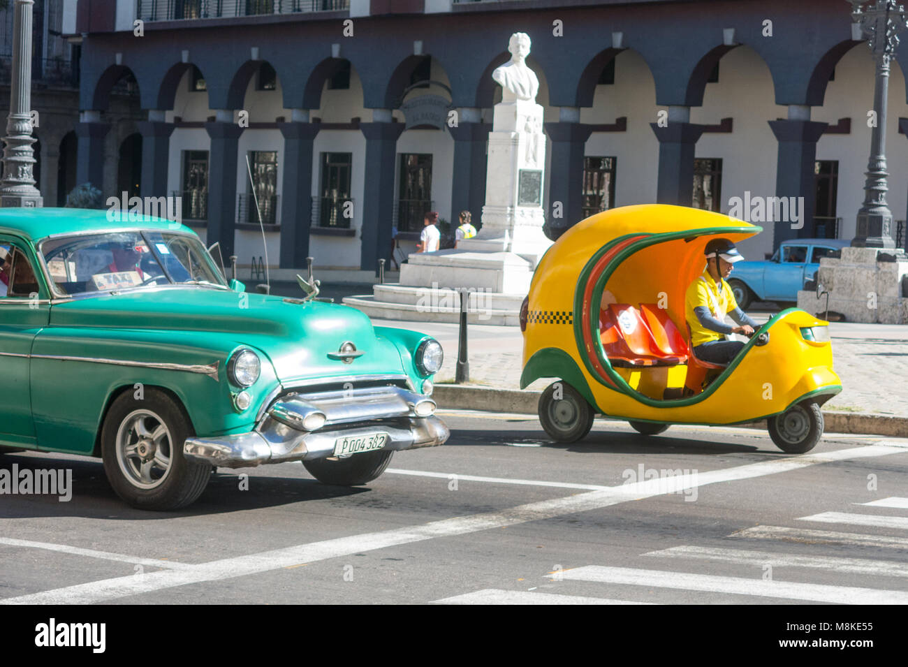 Old car and Cocotaxi in Old Havana. Coco taxi is an auto rickshaw type ...