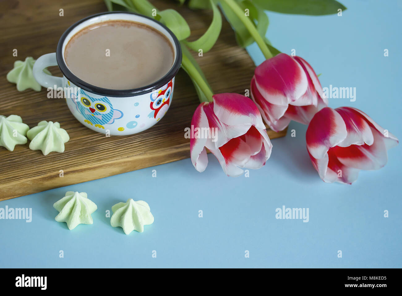 Red tulip white white border on blue background cacao cup marshmallow ...
