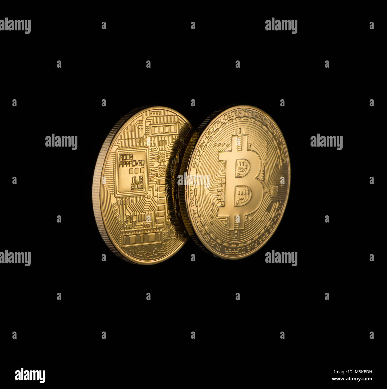 two Golden bitcoins on black background with copy space. electronic ...