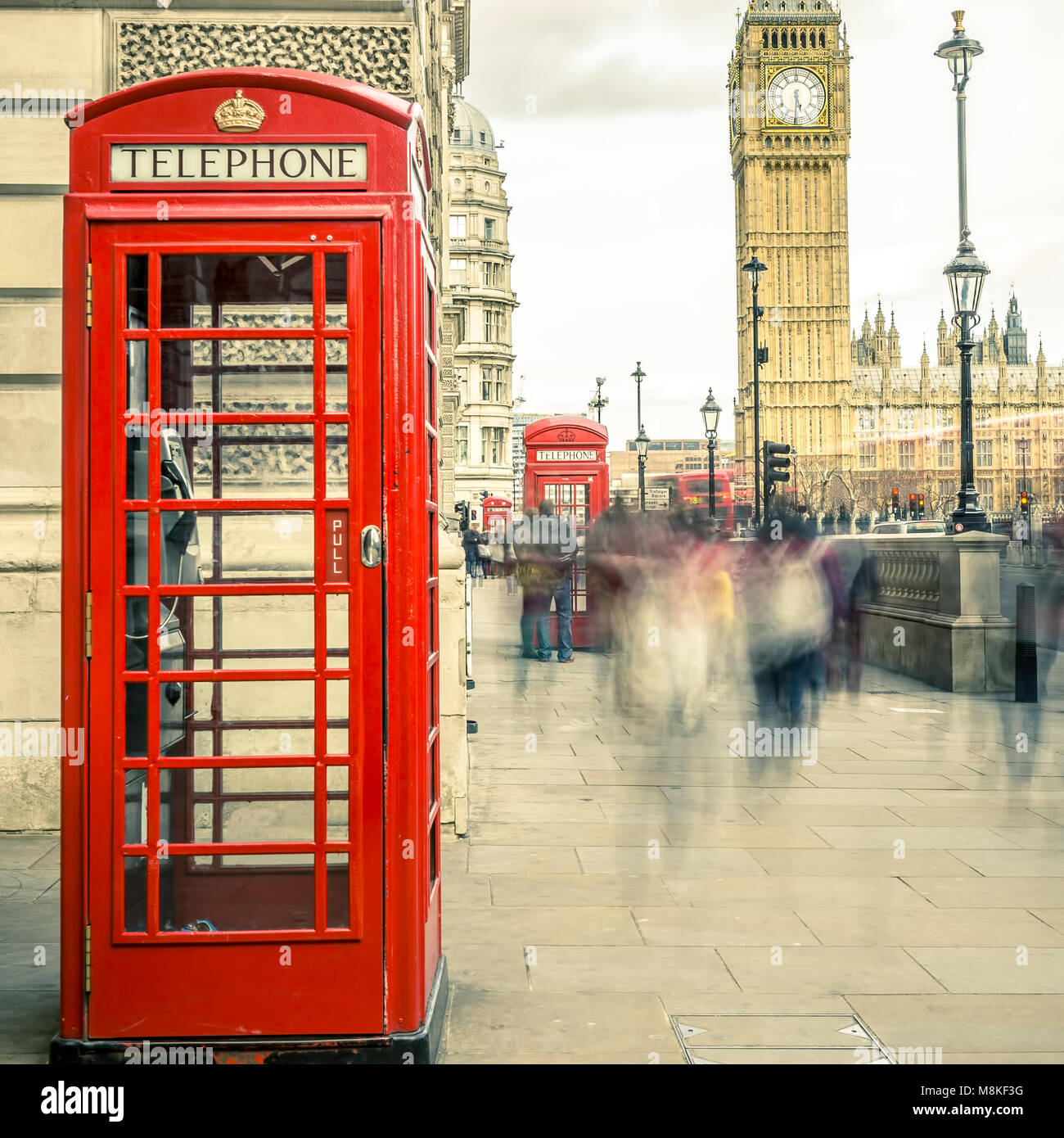 The iconic british old red telephone box with the Big Ben at background ...