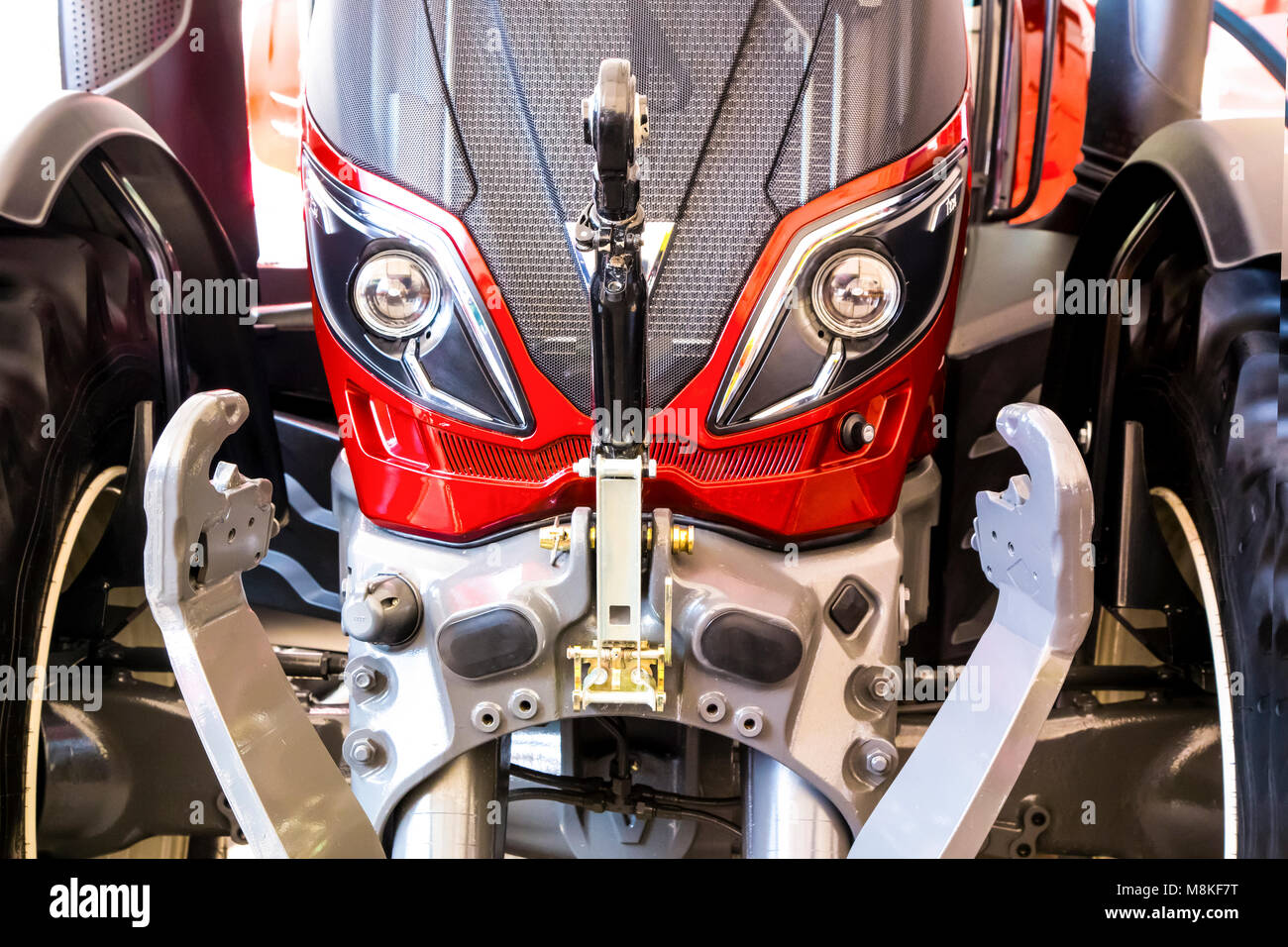 new, red-gray tractor front, close-up, background image ...