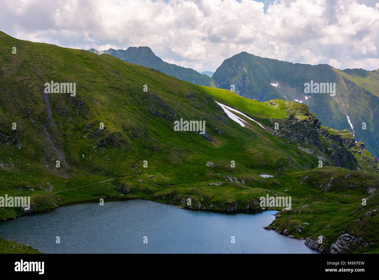 lake Capra in Fagarasan mountains of Romania. beautiful summer scenery ...