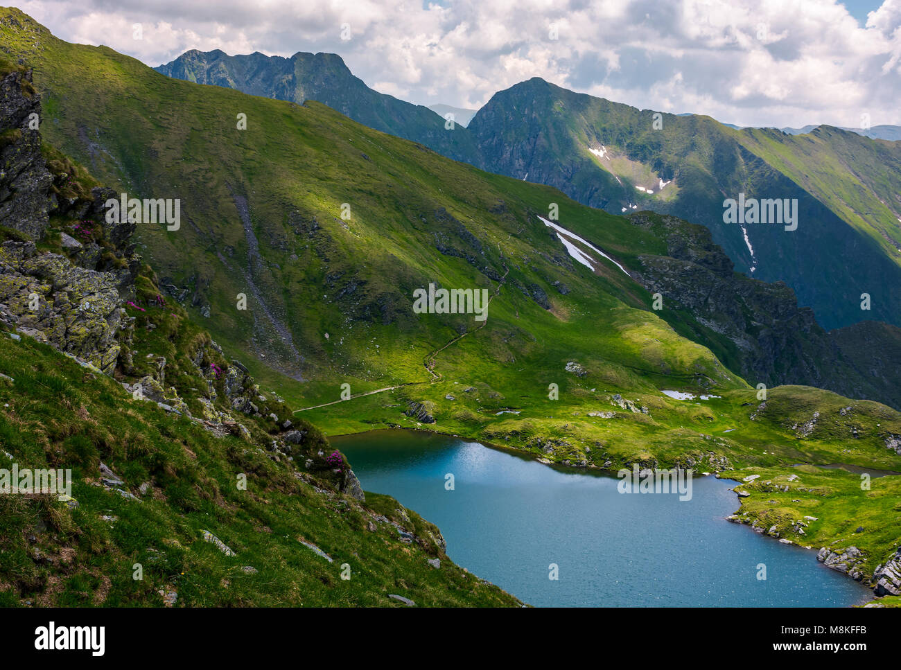 lake Capra in Fagarasan mountains of Romania. beautiful summer scenery ...