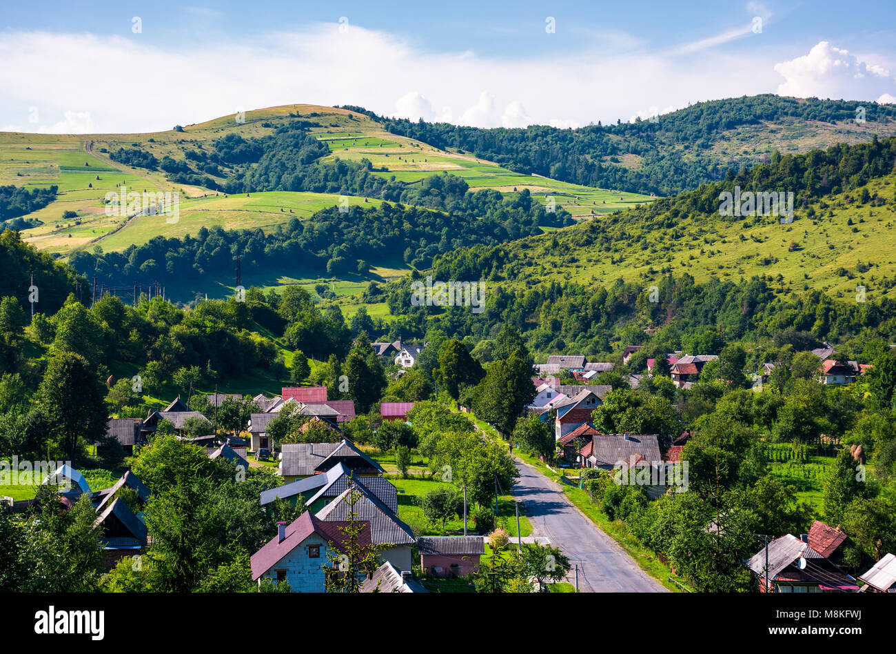 road through village in Carpathian mountains. bird eye view of beautiful rural scenery in ...